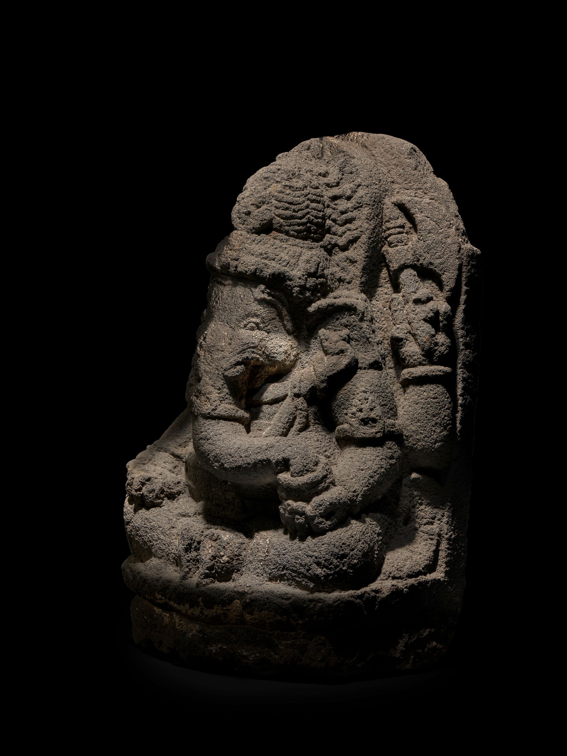 Bonhams : AN ANDESITE FIGURE OF GANESHA JAVA, INDONESIA, CIRCA 11TH CENTURY