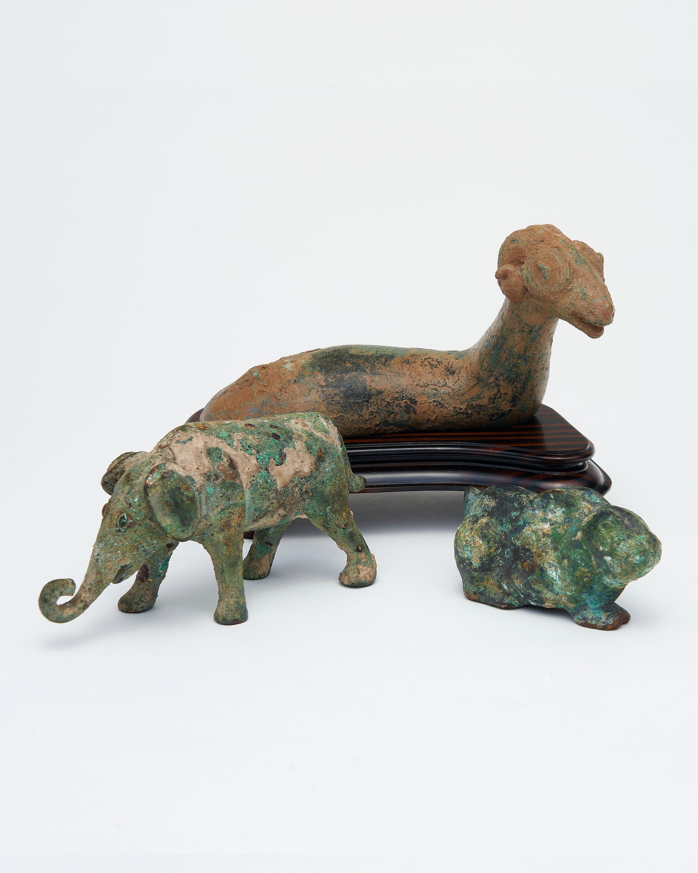 Bonhams : Three bronze figures of a reclining ram, an elephant and a ...