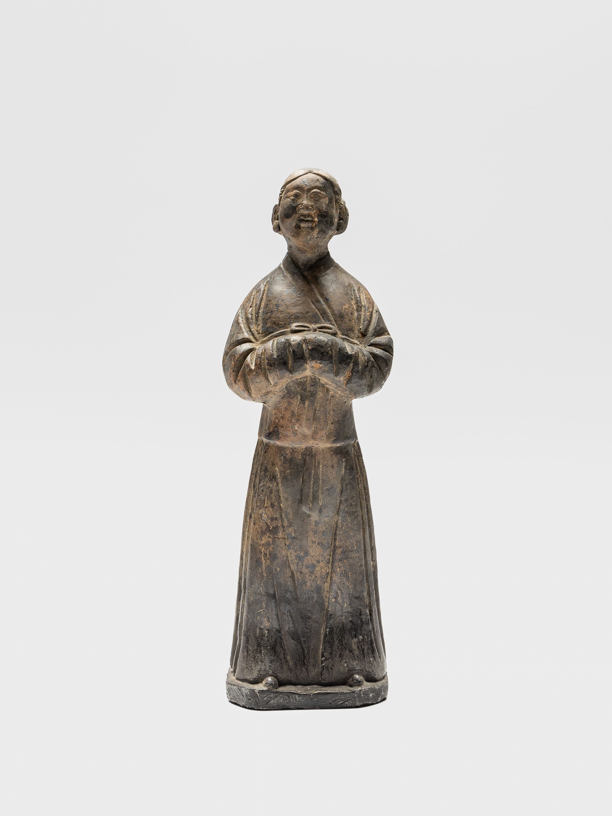 Bonhams : A pottery figure of a standing lady Yuan dynasty